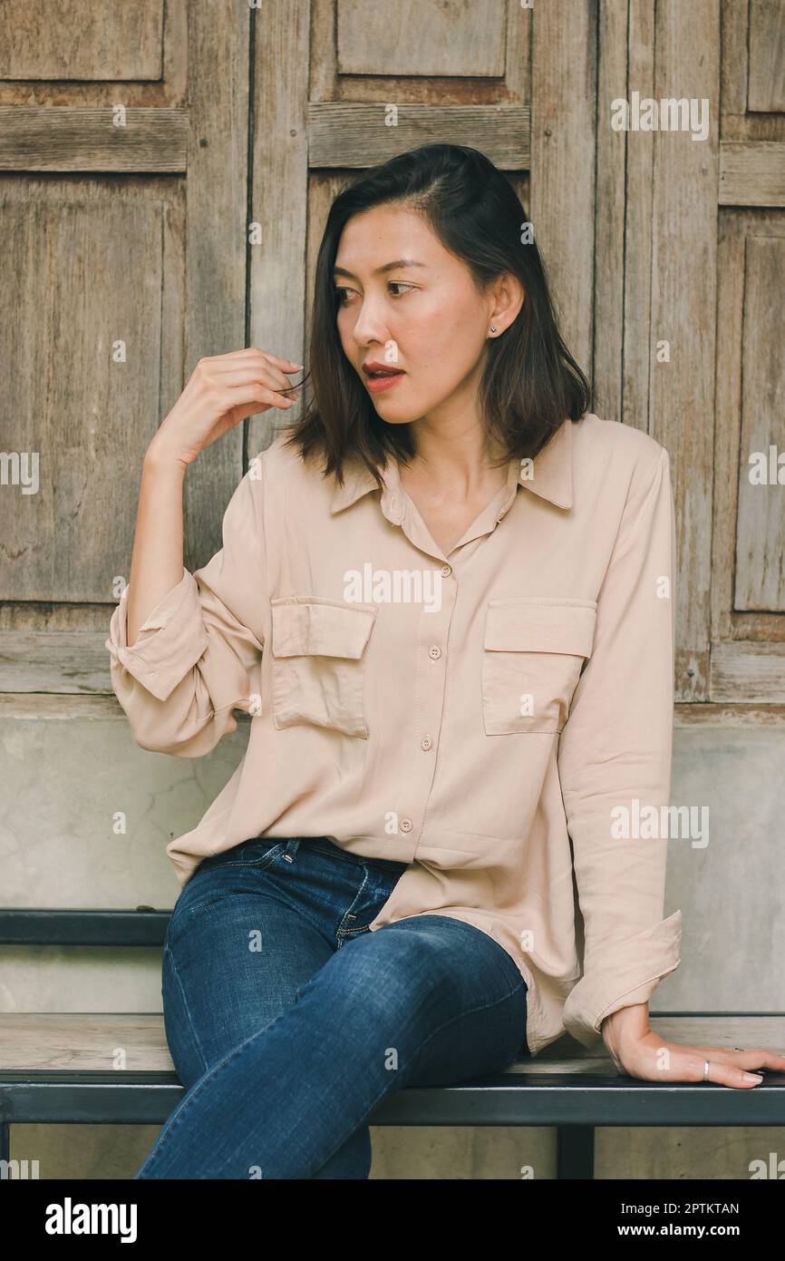 Women are sitting against the wooden window Stock Photo - Alamy
