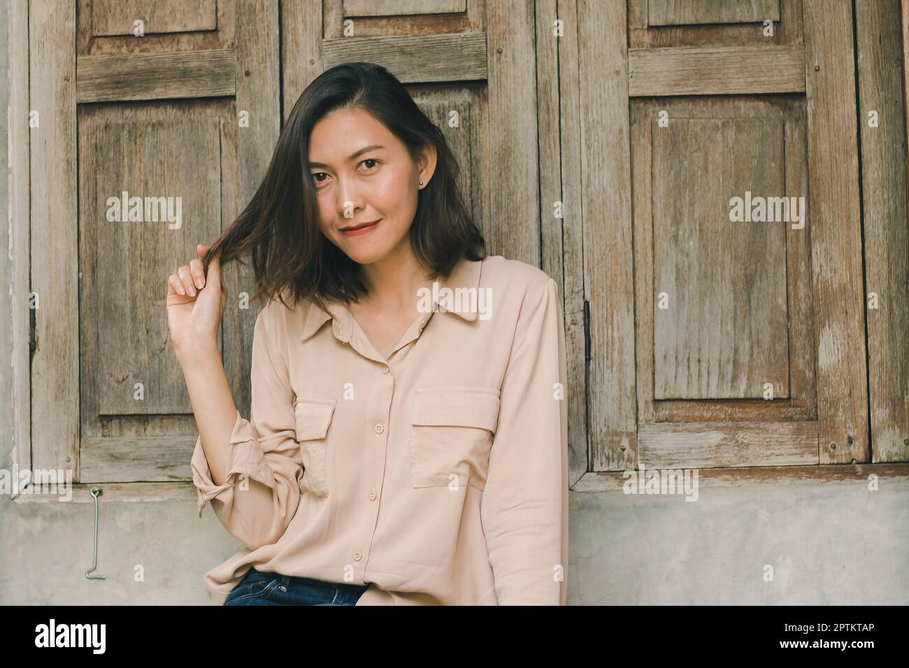 Women are sitting against the wooden window Stock Photo - Alamy