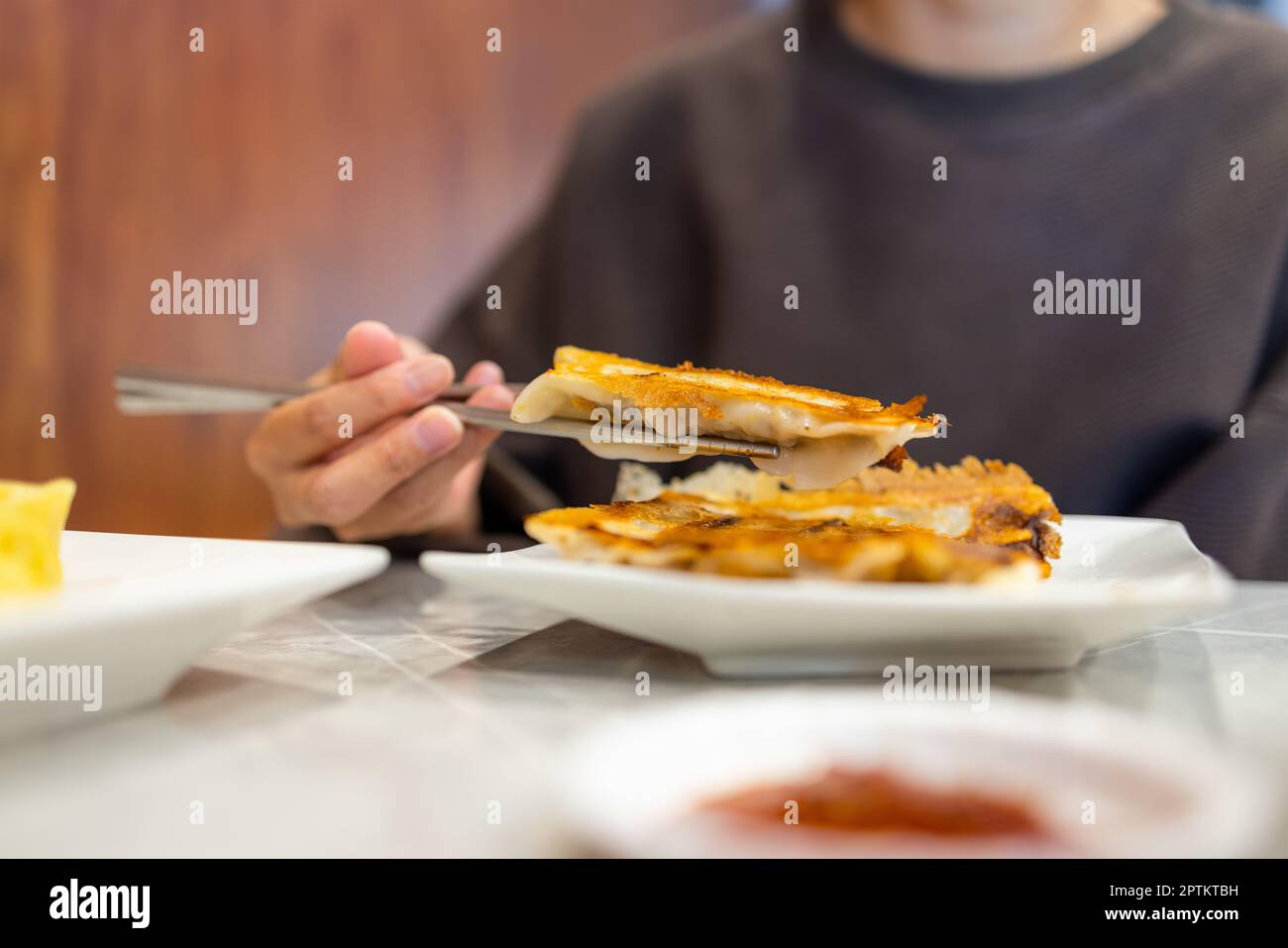 Woman eat grill dumpling in restaurant Stock Photo - Alamy