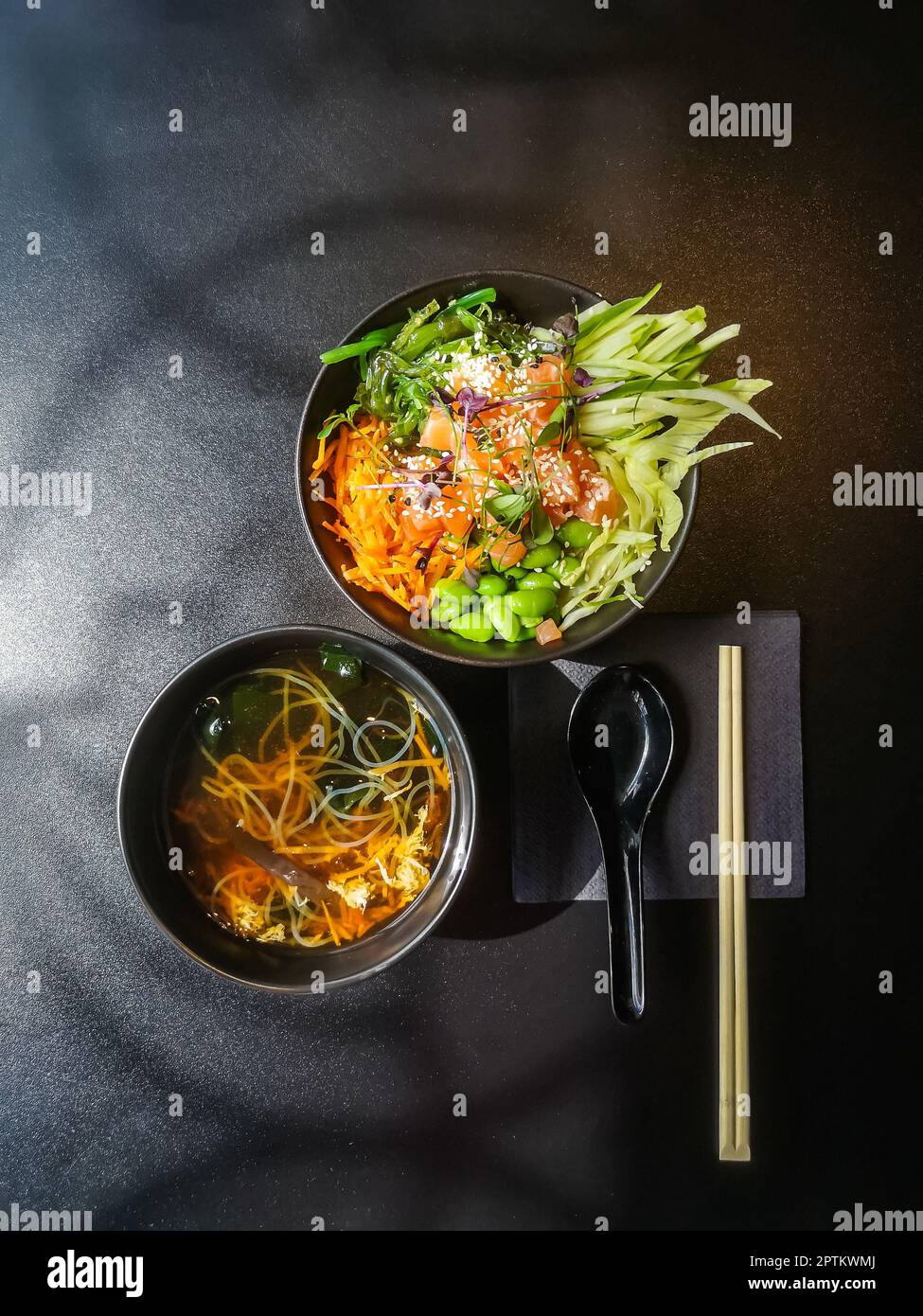 Japanese-style lunch. Bowl with fresh salmon, carrots, cucumbers, green ...