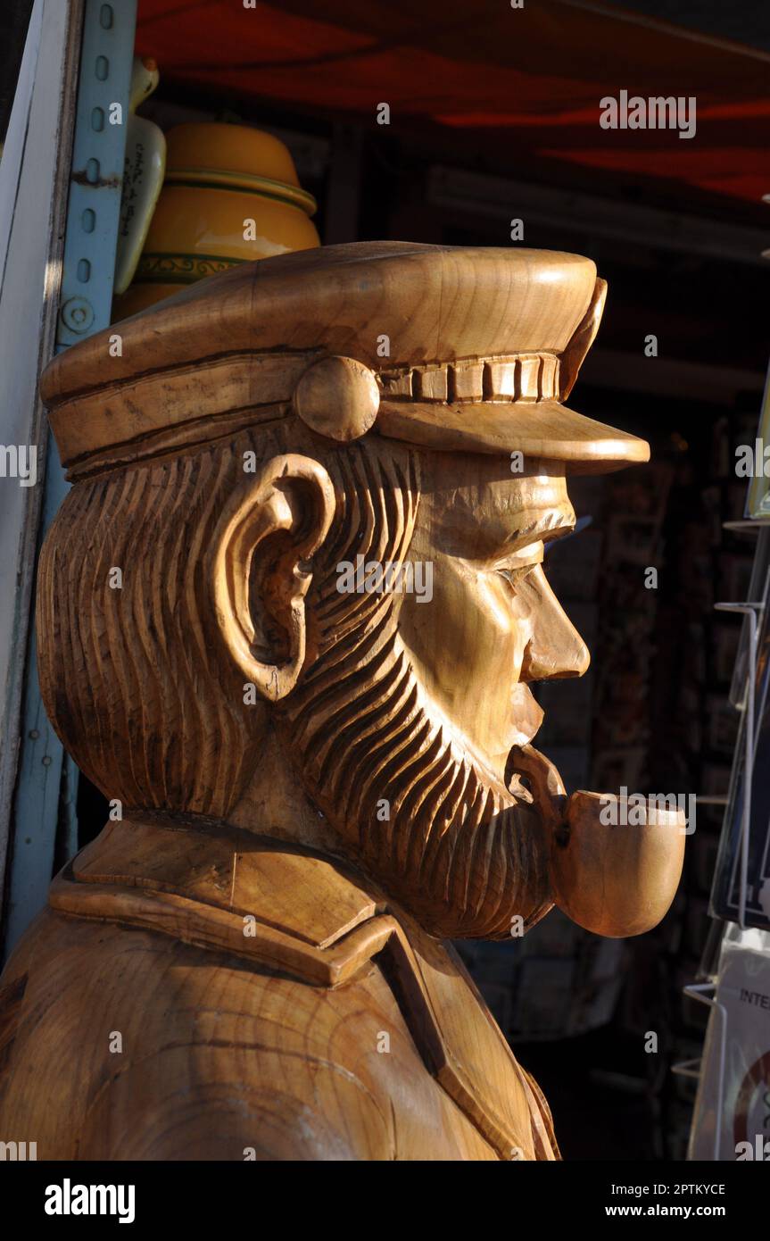 Wooden sculpture of an old sailor with a pipe Stock Photo - Alamy