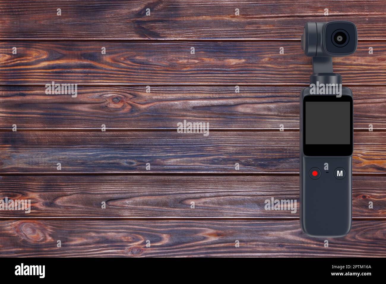 Pocket Handheld Gimbal Action Camera on a plank wooden table background ...