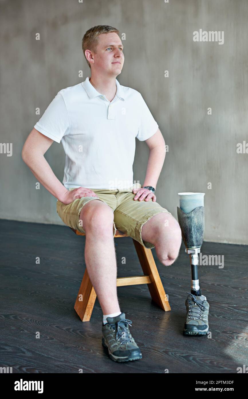 Even his disability cant stop him. a young amputee sitting in a gym ...