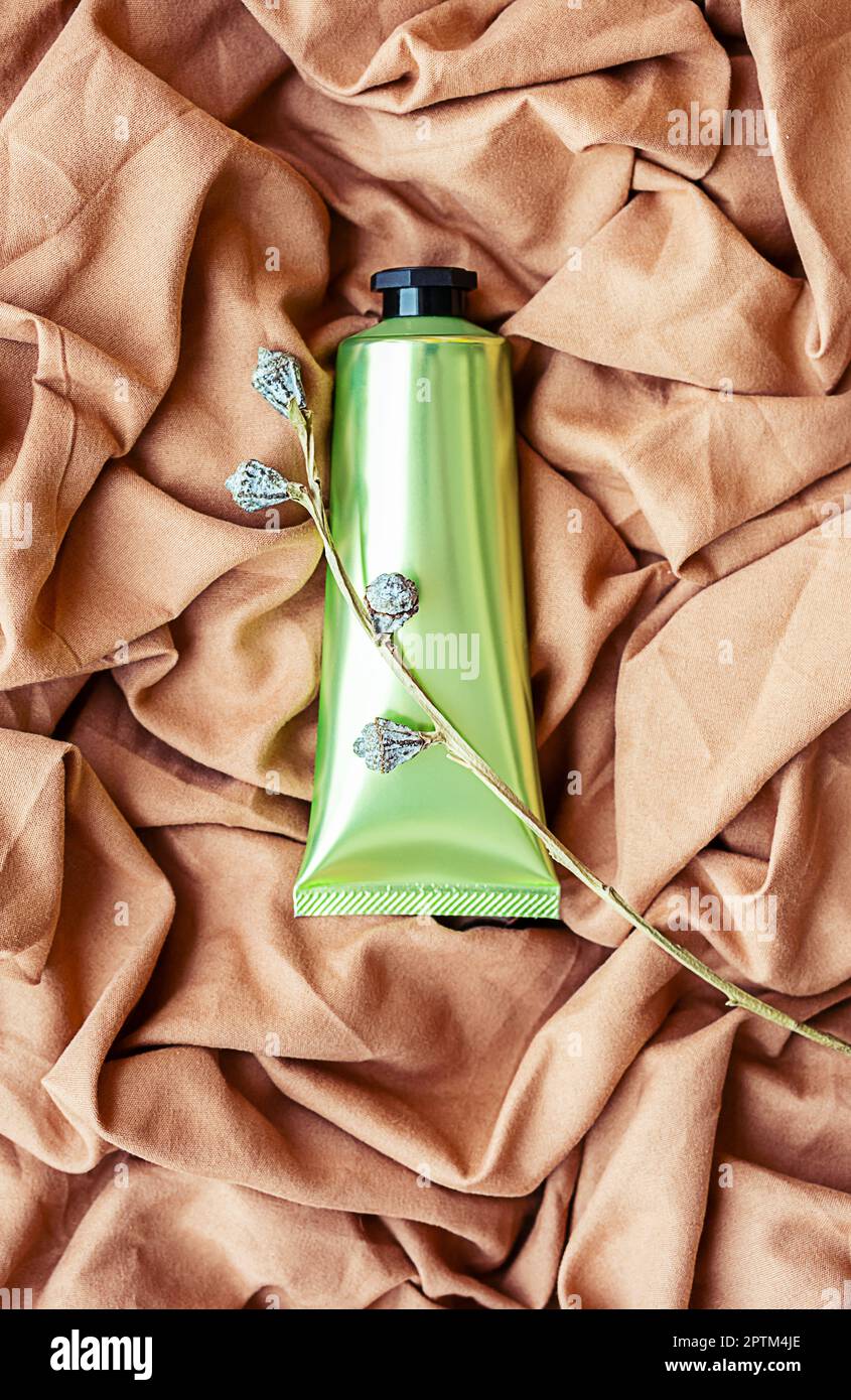 Cosmetic tube on textile background. Skin care beauty product layout ...