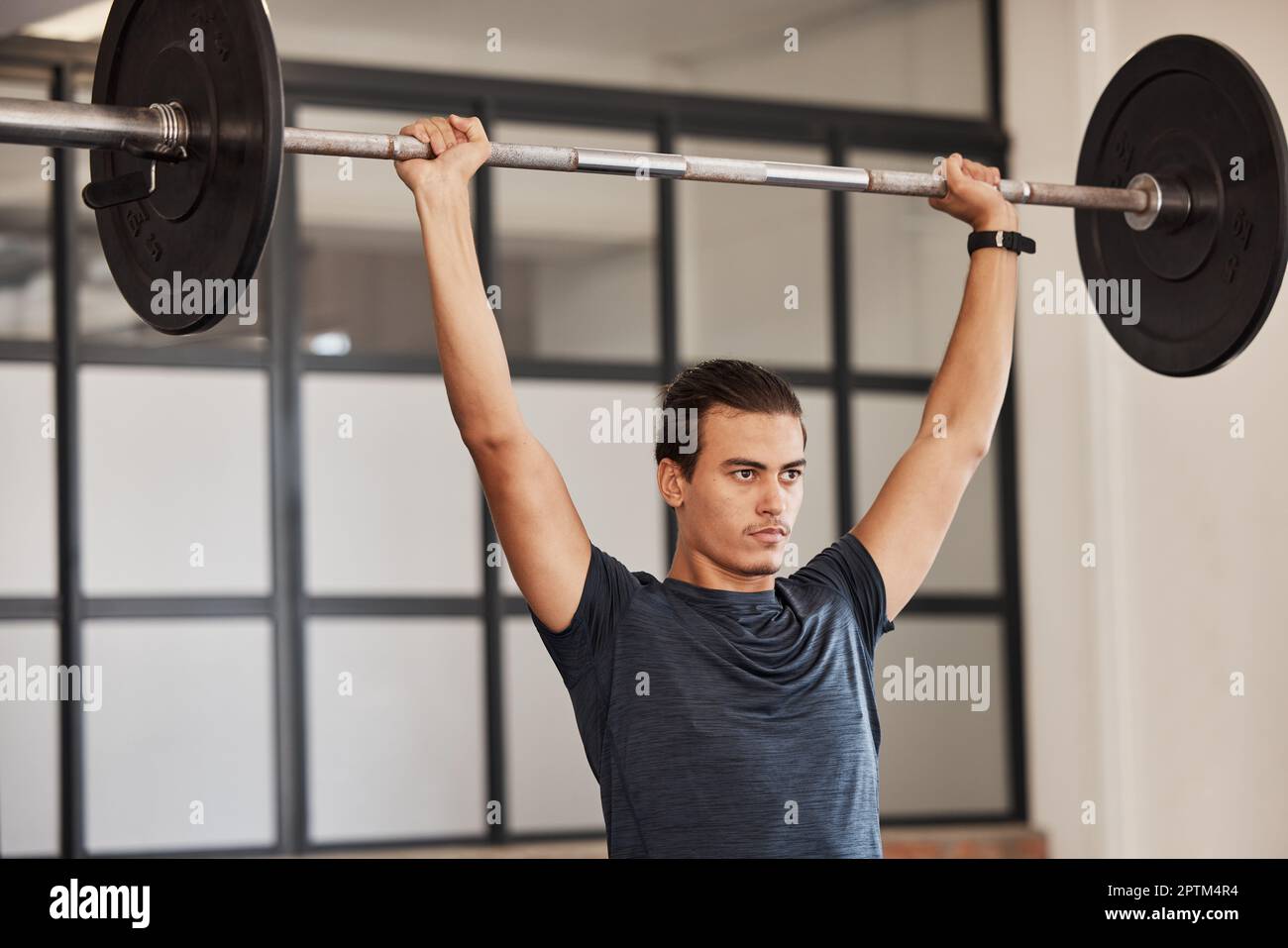 Strong man, overhead barbell and gym exercise, workout and fitness ...