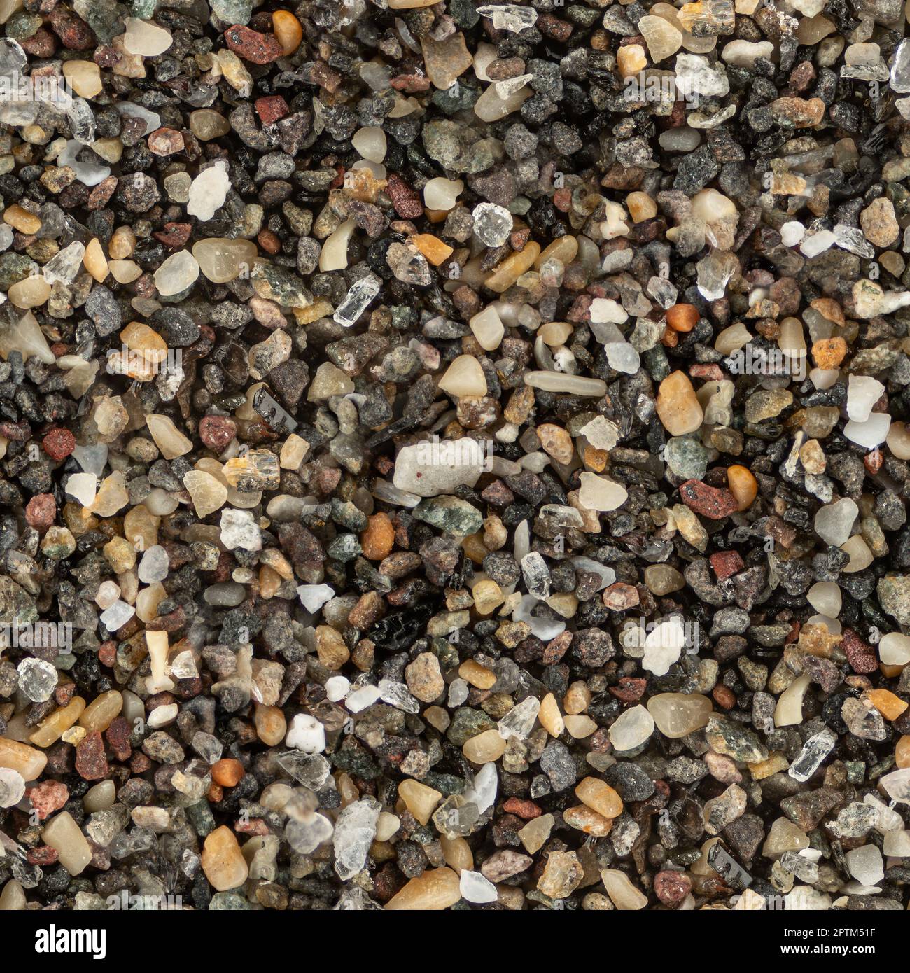 Sea sand with dark volcanic particles, microscope photo made into ...
