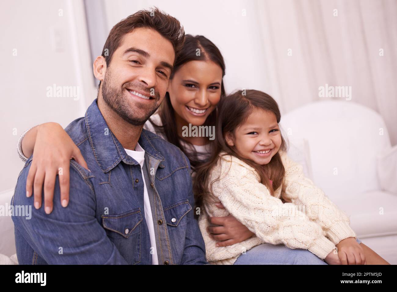 Love is at the centre of their home. Portrait of a happy young family ...