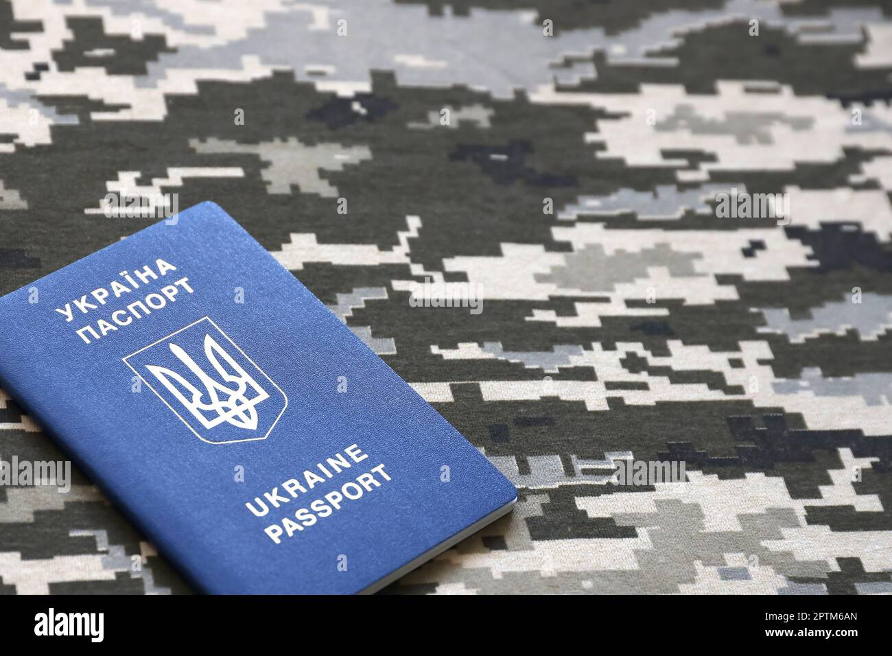 Ukrainian foreign passport on fabric with texture of military pixeled ...