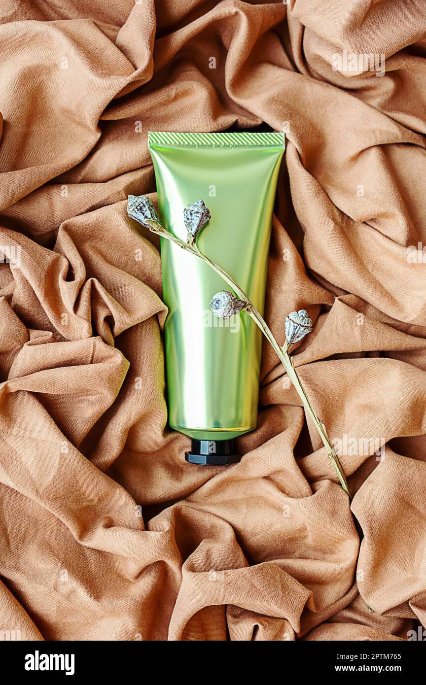 Cosmetic tube on textile background. Skin care beauty product layout ...