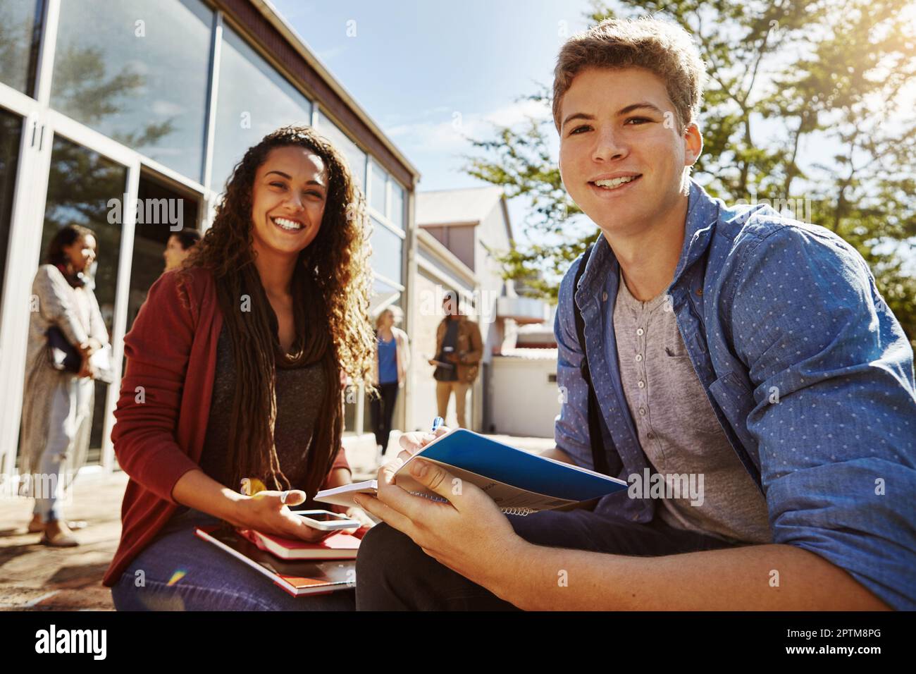 We help each other by sharing our knowledge. two students studying ...