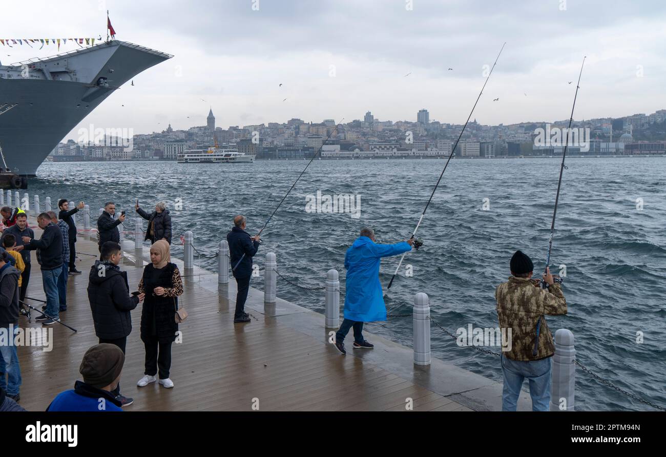 Istanbul, Turkey. 20 April, 2023 — Several men are fishing as other ...