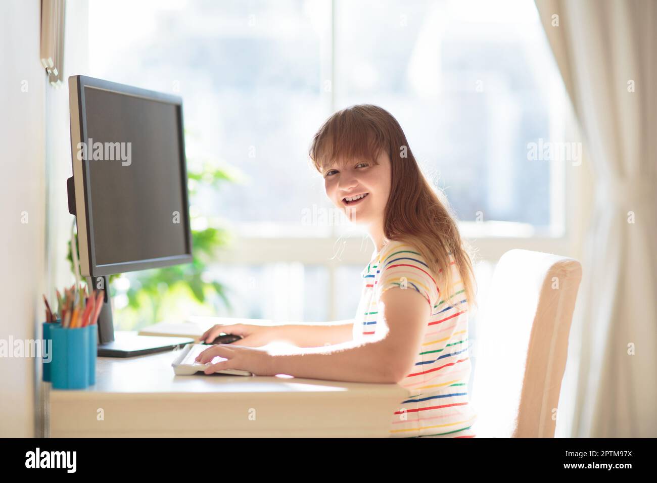 Child doing homework on computer. Online class. Homeschooling and ...