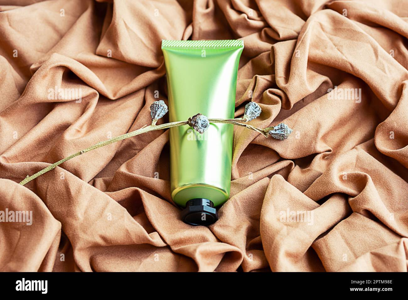 Cosmetic tube on textile background. Skin care beauty product layout ...
