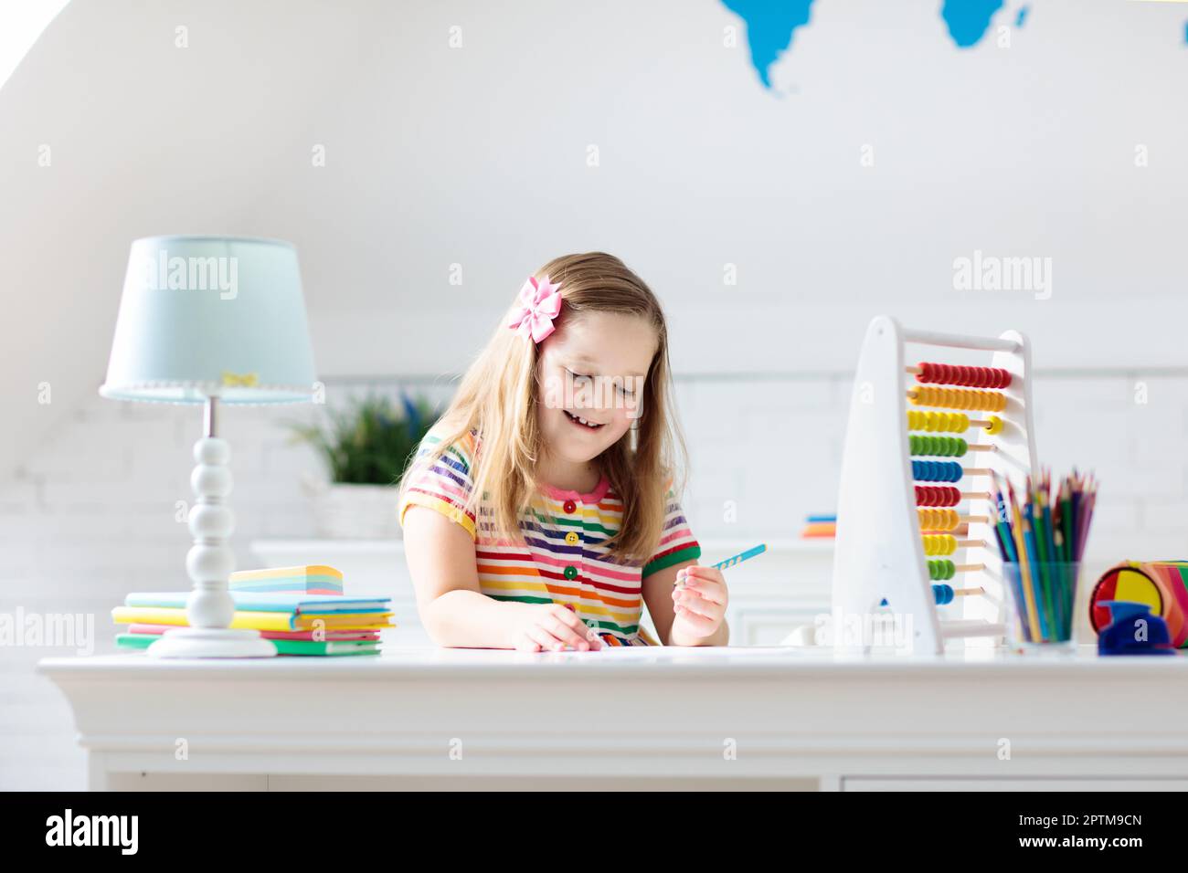 Child doing homework at home. Little girl with wooden colorful abacus ...