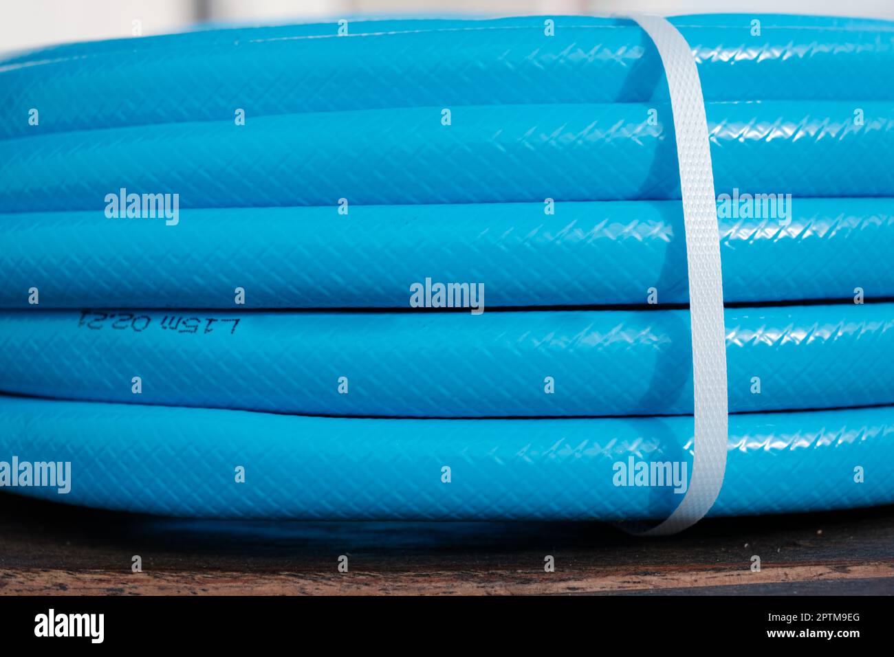 Detail of the rubber material of a new blue hose, built with recycled ...
