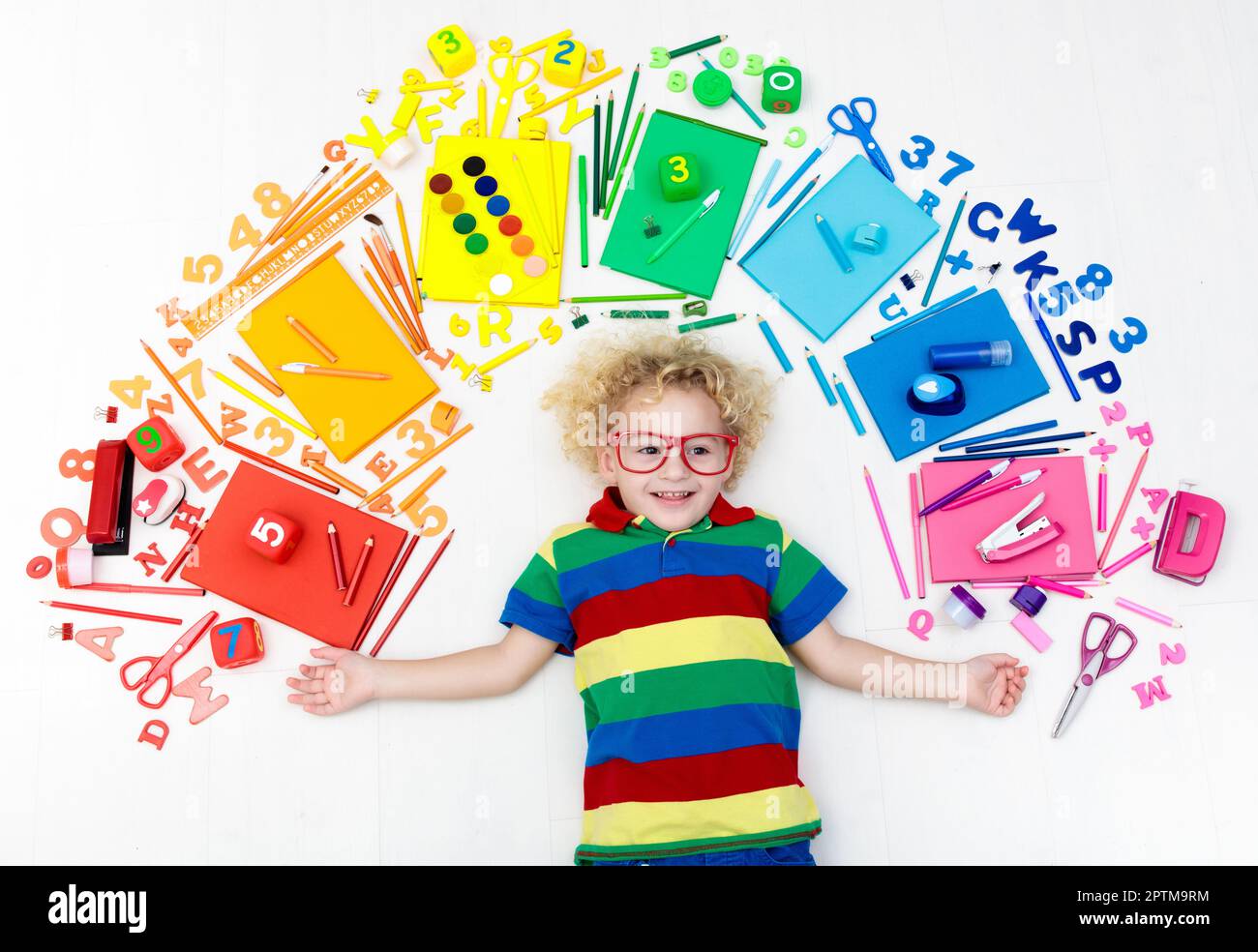 Little boy with school supplies, books, drawing and painting tools and ...