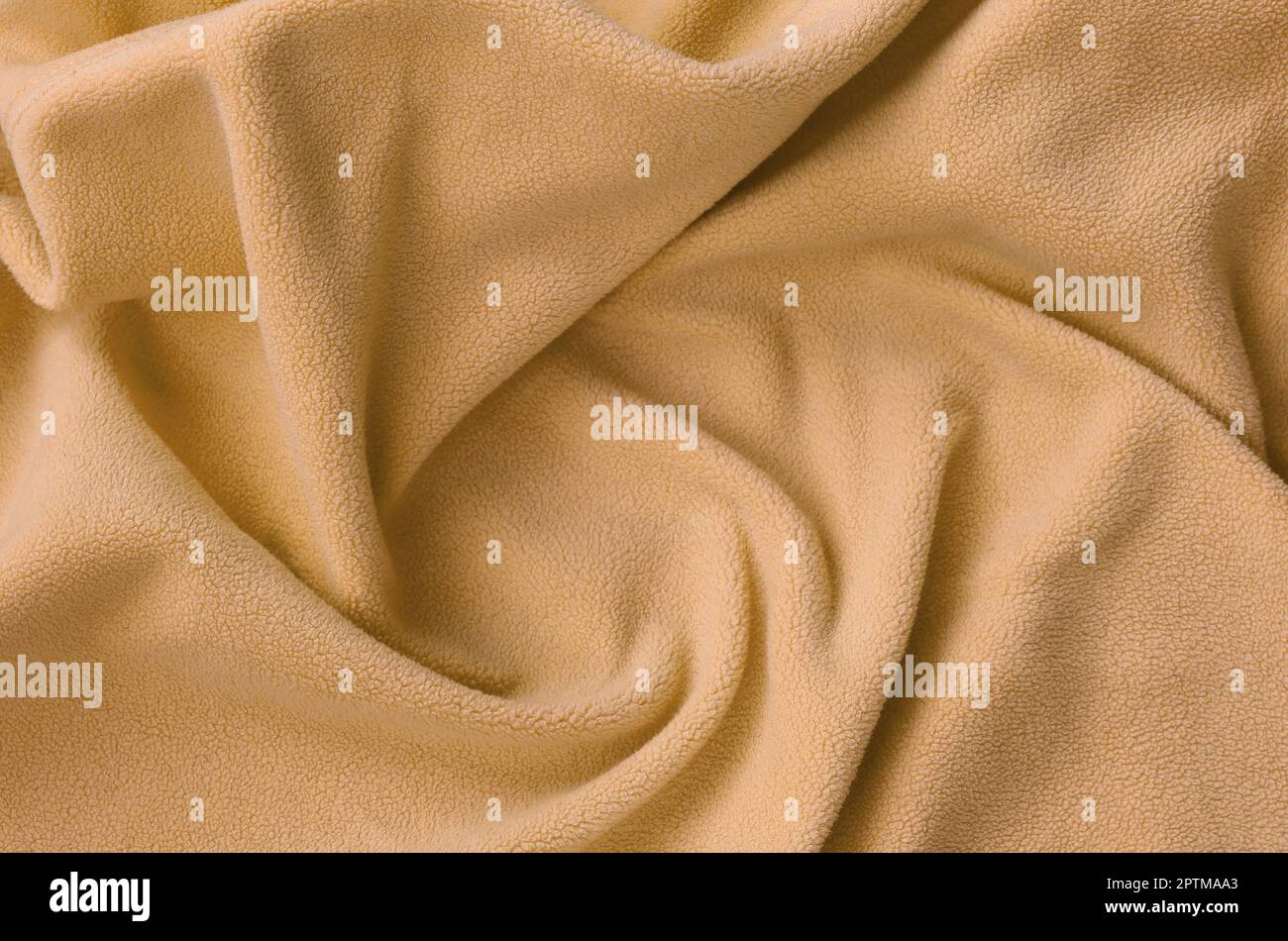 The blanket of furry orange fleece fabric. A background of light orange ...