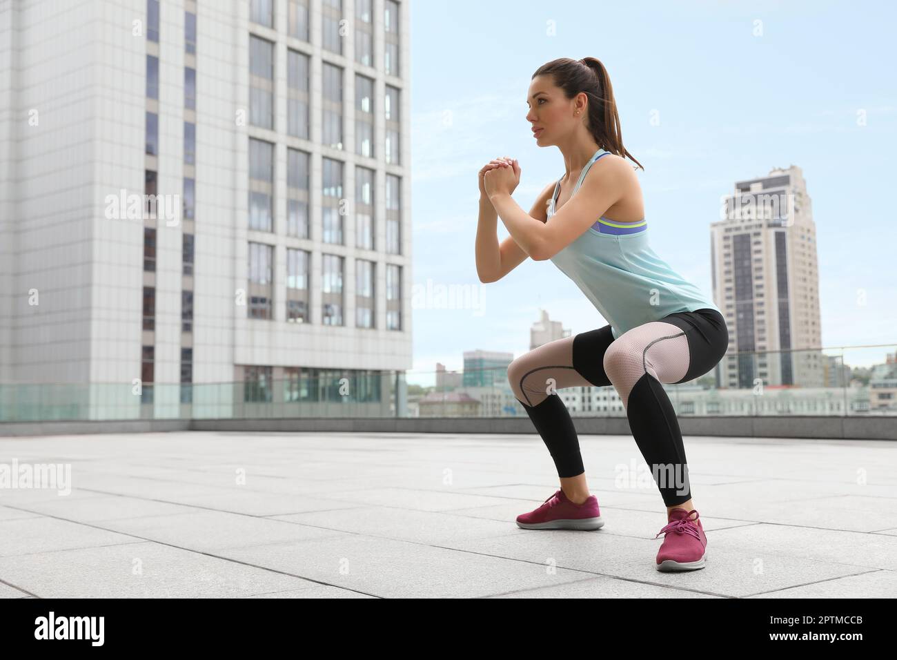 Beautiful woman doing fitness exercise in morning outdoors Stock Photo ...