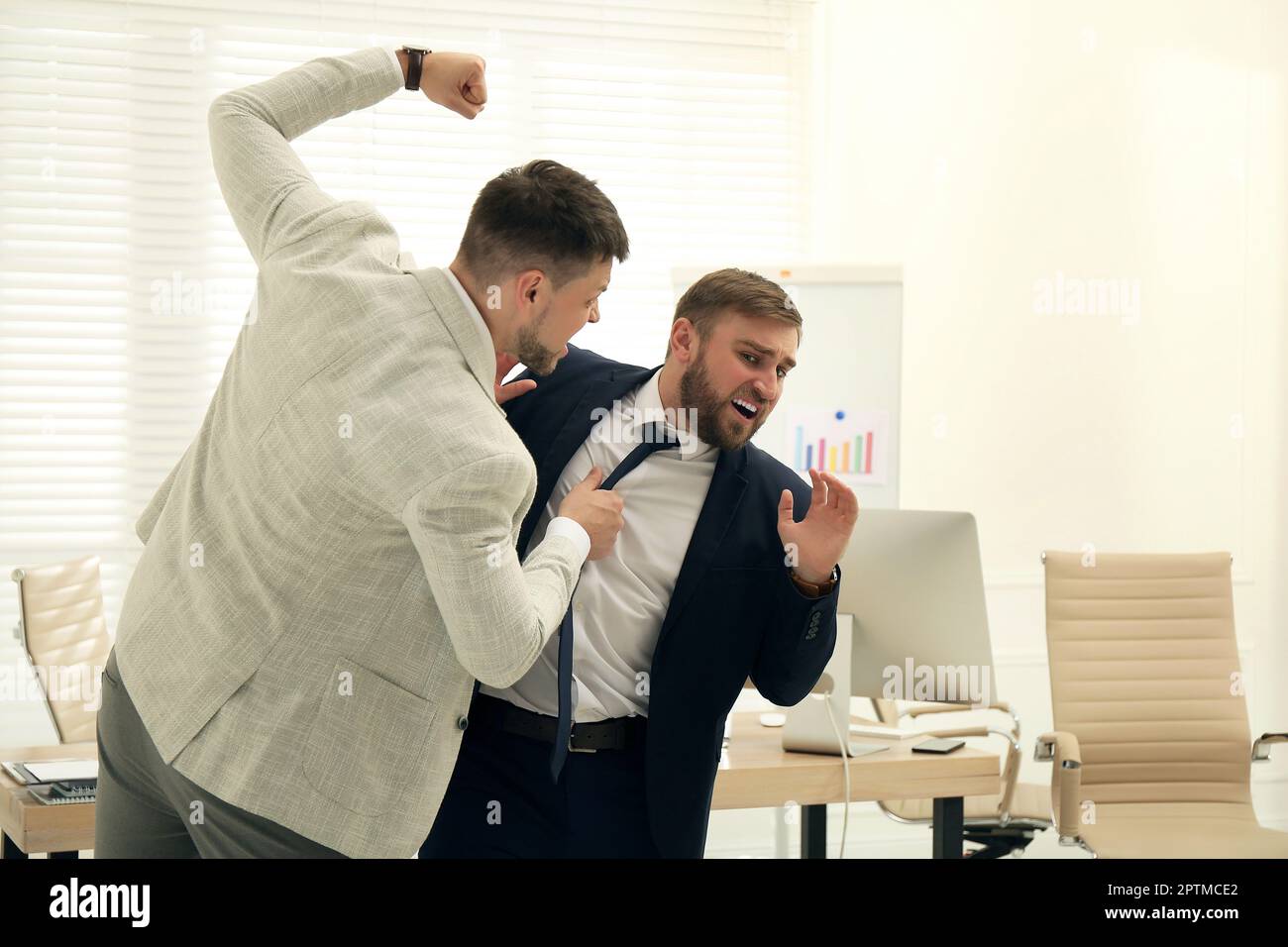 Emotional colleagues fighting in office. Workplace conflict Stock Photo ...