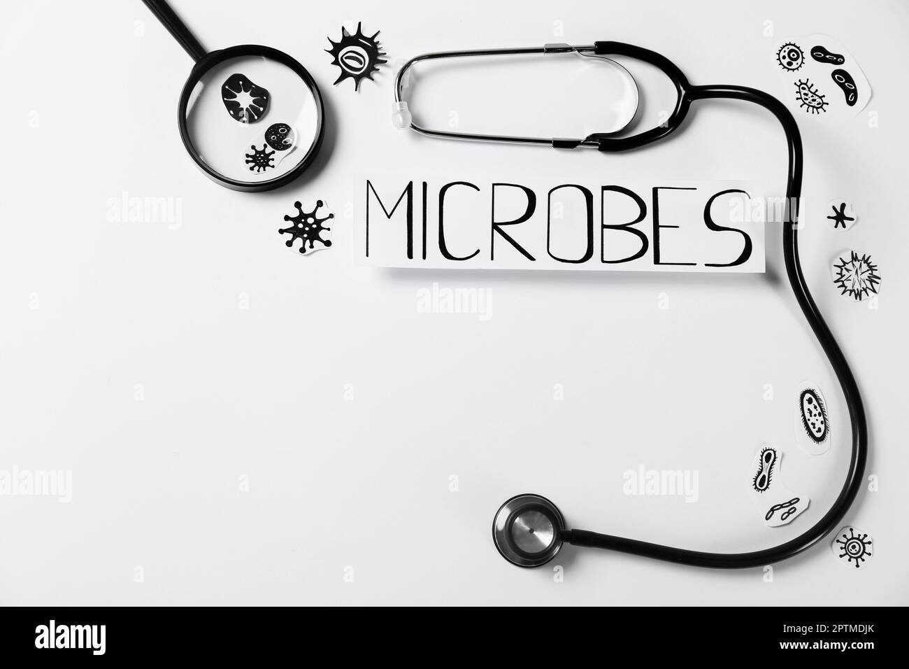 Card with word Microbes, pictures, magnifying glass and stethoscope on ...