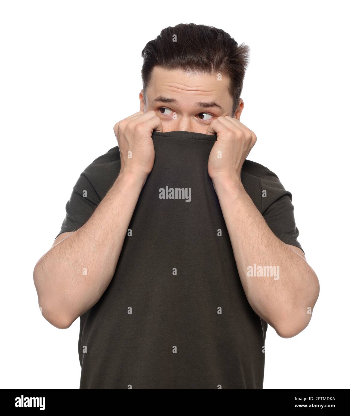 Embarrassed man covering face with t-shirt on white background Stock ...