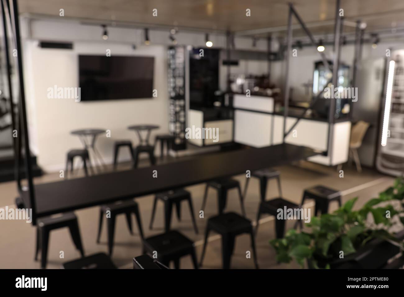 Blurred view of hostel dining room interior with comfortable furniture ...
