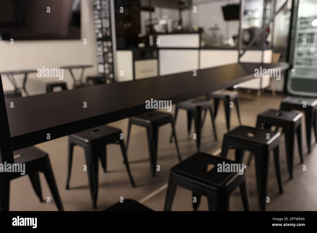 Blurred view of hostel dining room interior with comfortable furniture ...