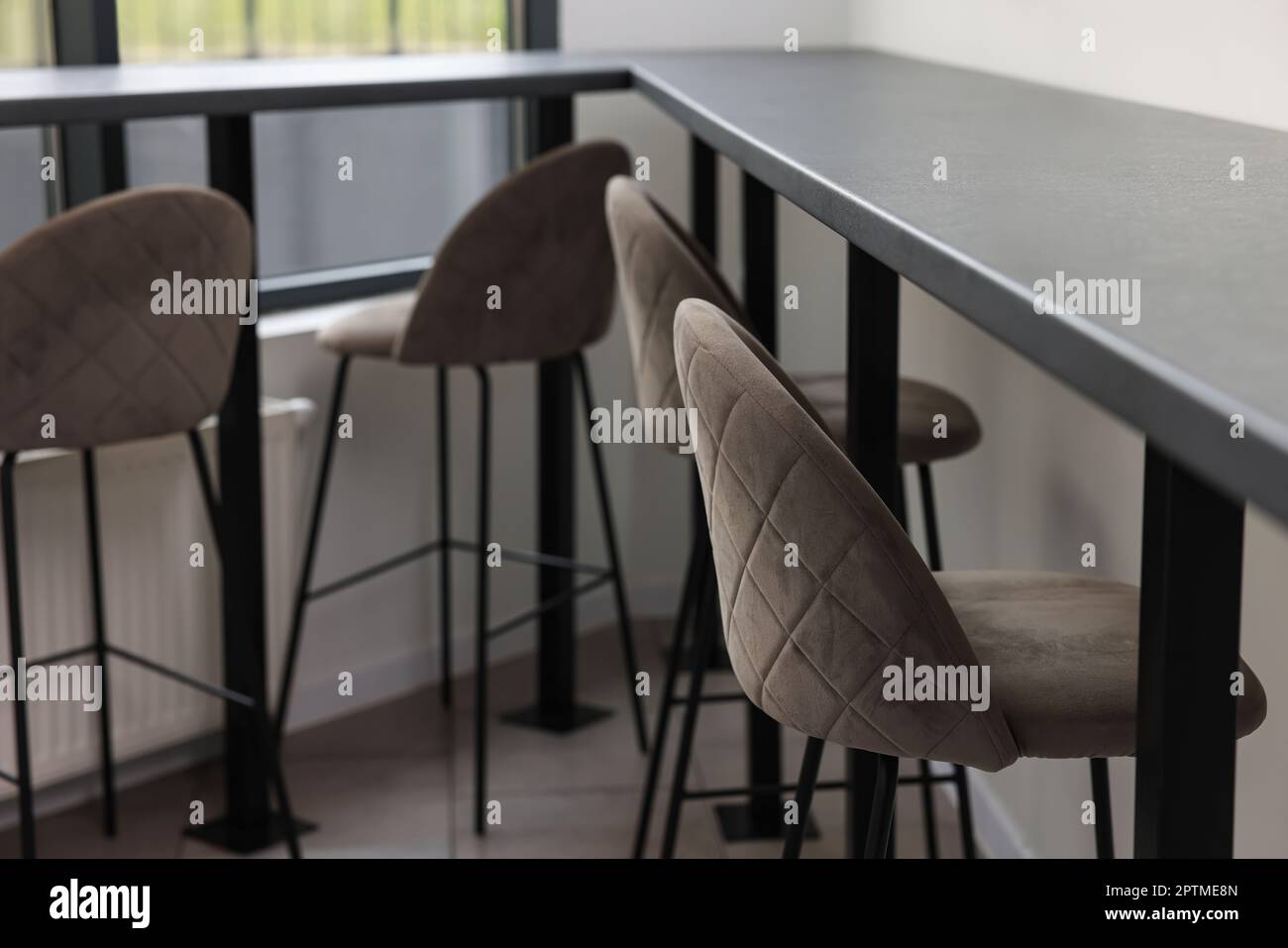 Tables and bar stools in hostel dining room Stock Photo - Alamy