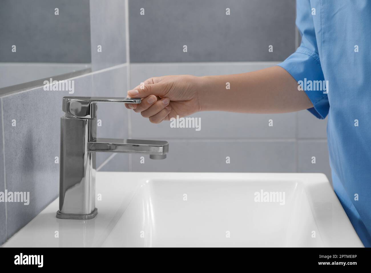 Doctor opening tap water in bathroom, closeup Stock Photo - Alamy