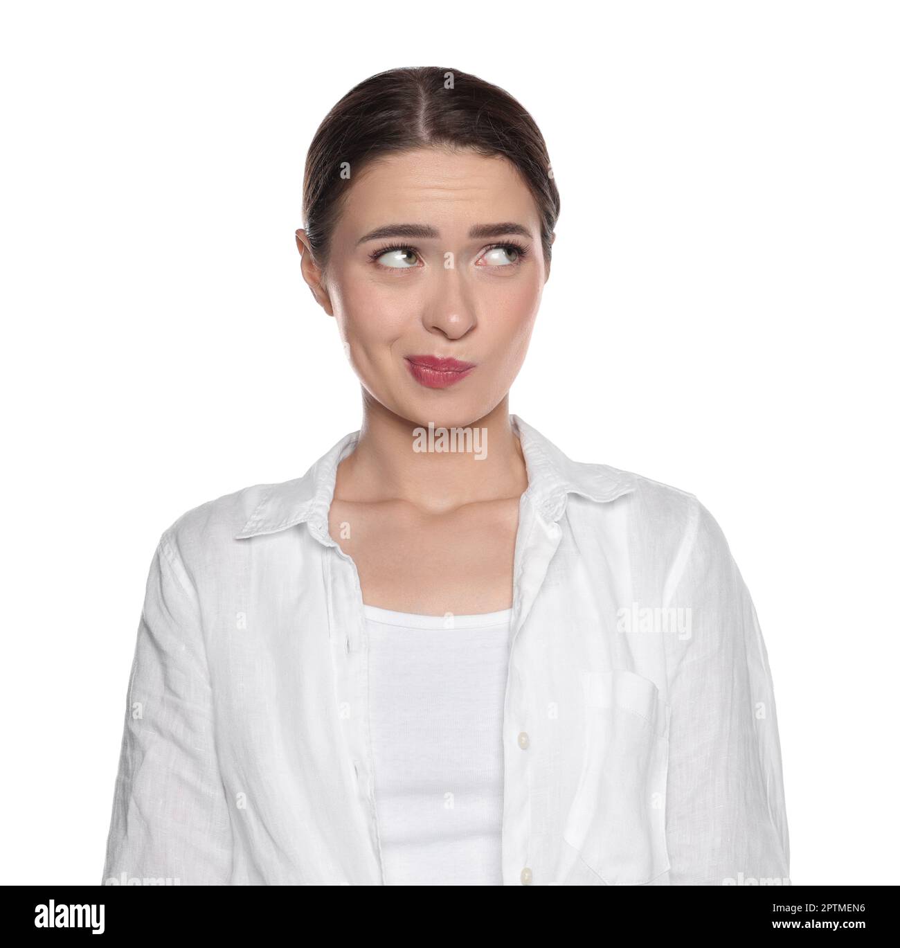 Embarrassed young woman in shirt on white background Stock Photo - Alamy