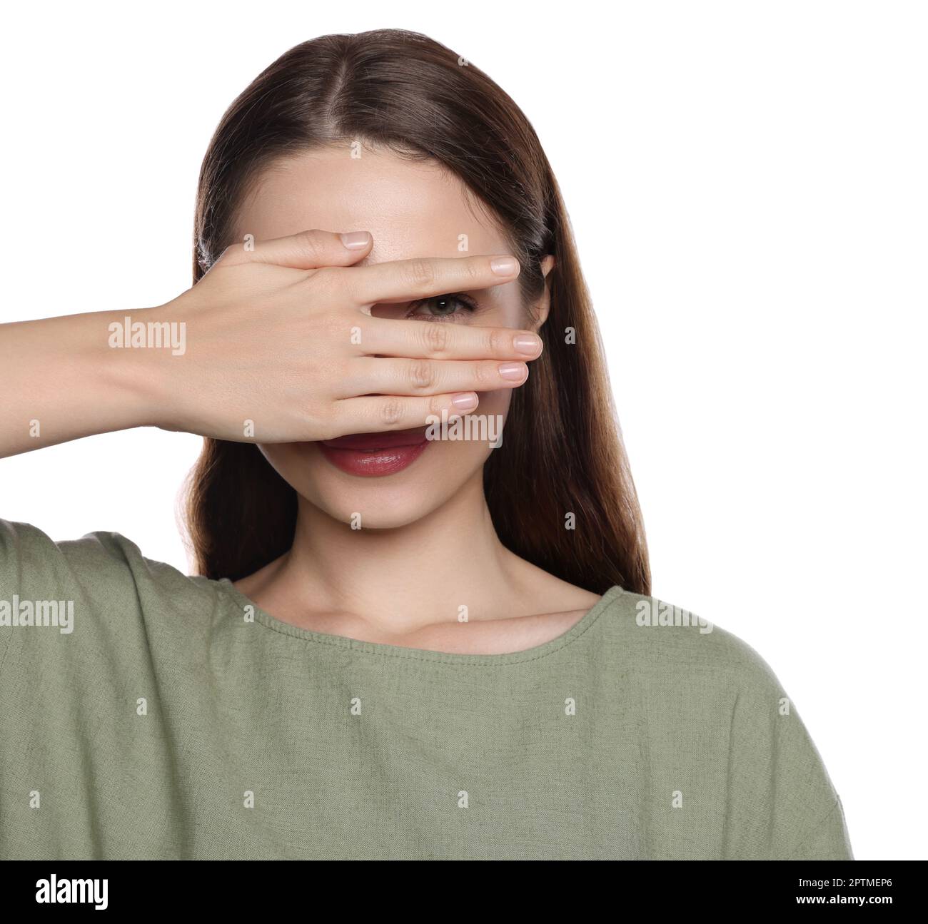 Embarrassed young woman covering face with hand on white background ...