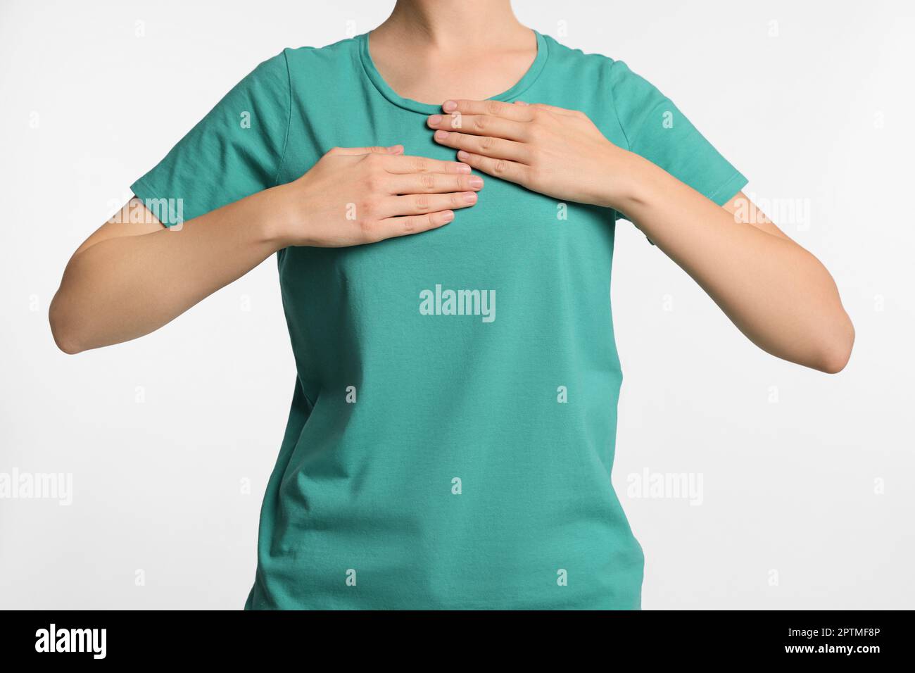 Woman holding hands near chest on light grey background, closeup Stock ...