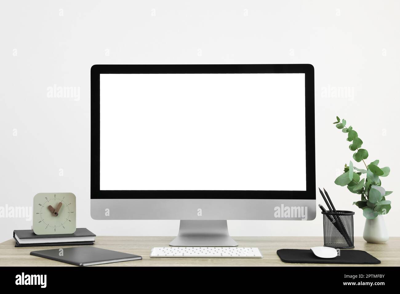 Modern computer with blank screen on desk, space for design ...