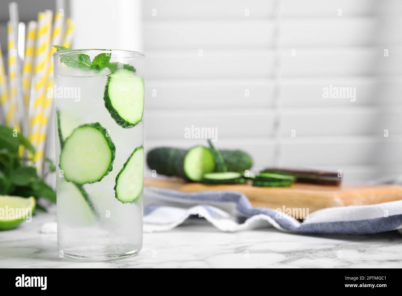 Glass of refreshing cucumber water with mint on white marble table, space for text Stock Photo ...