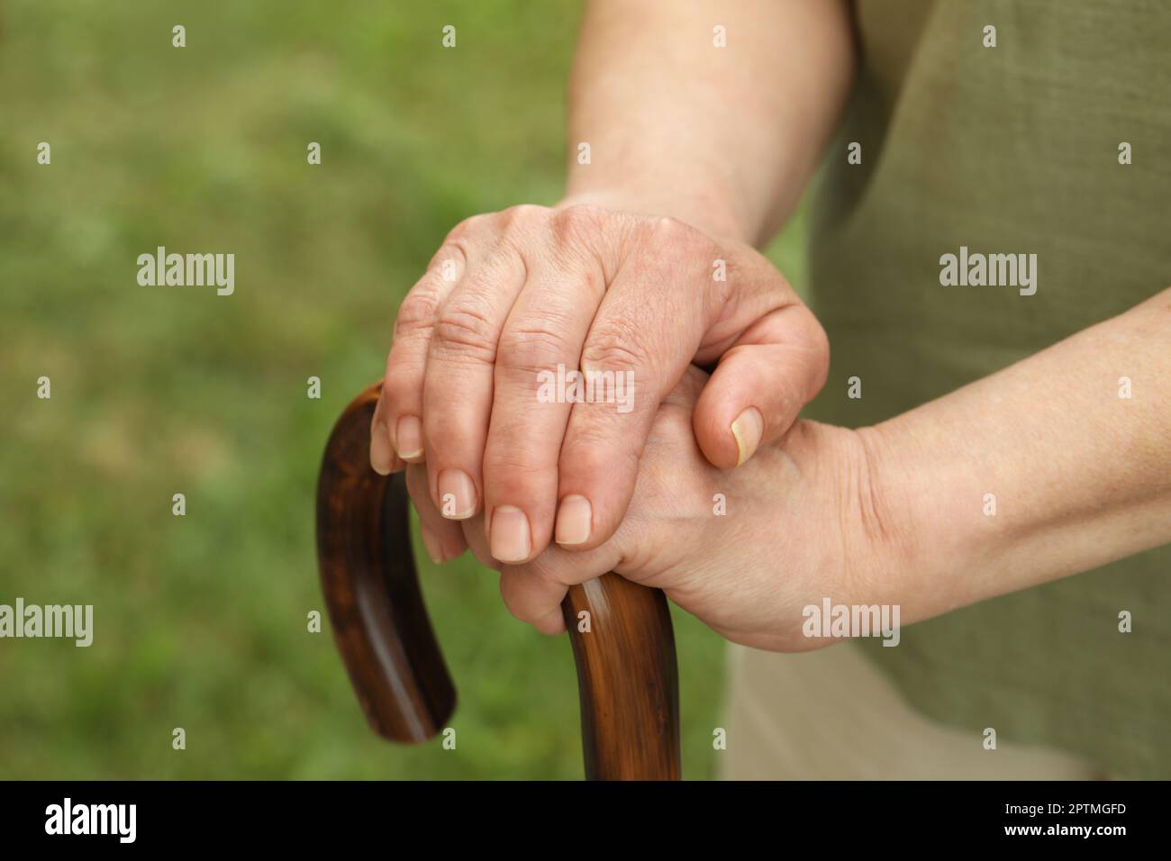 Elderly woman with walking cane outdoors, closeup Stock Photo - Alamy