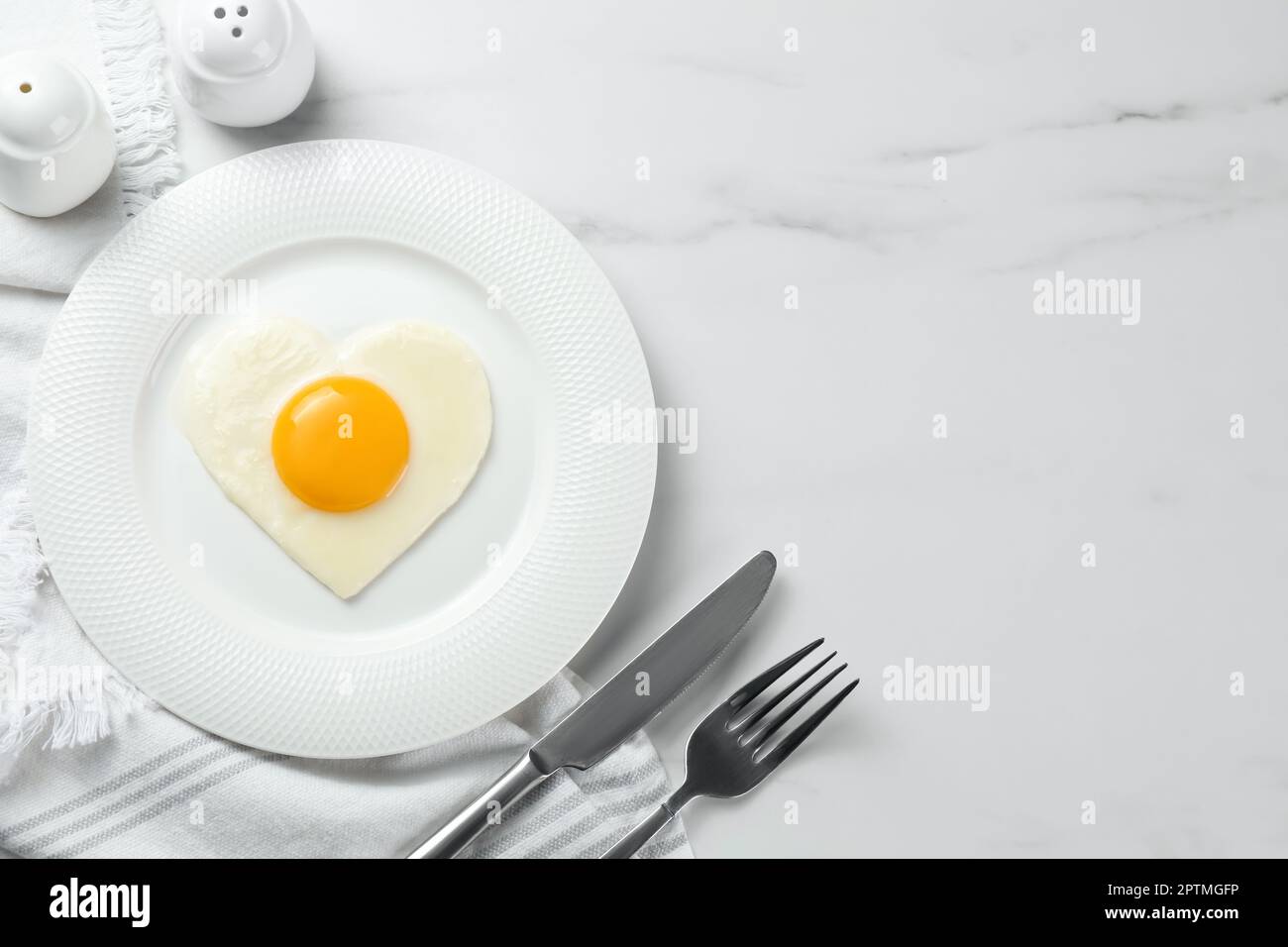 Heart shaped fried egg served on white marble table, flat lay. Space for text Stock Photo - Alamy