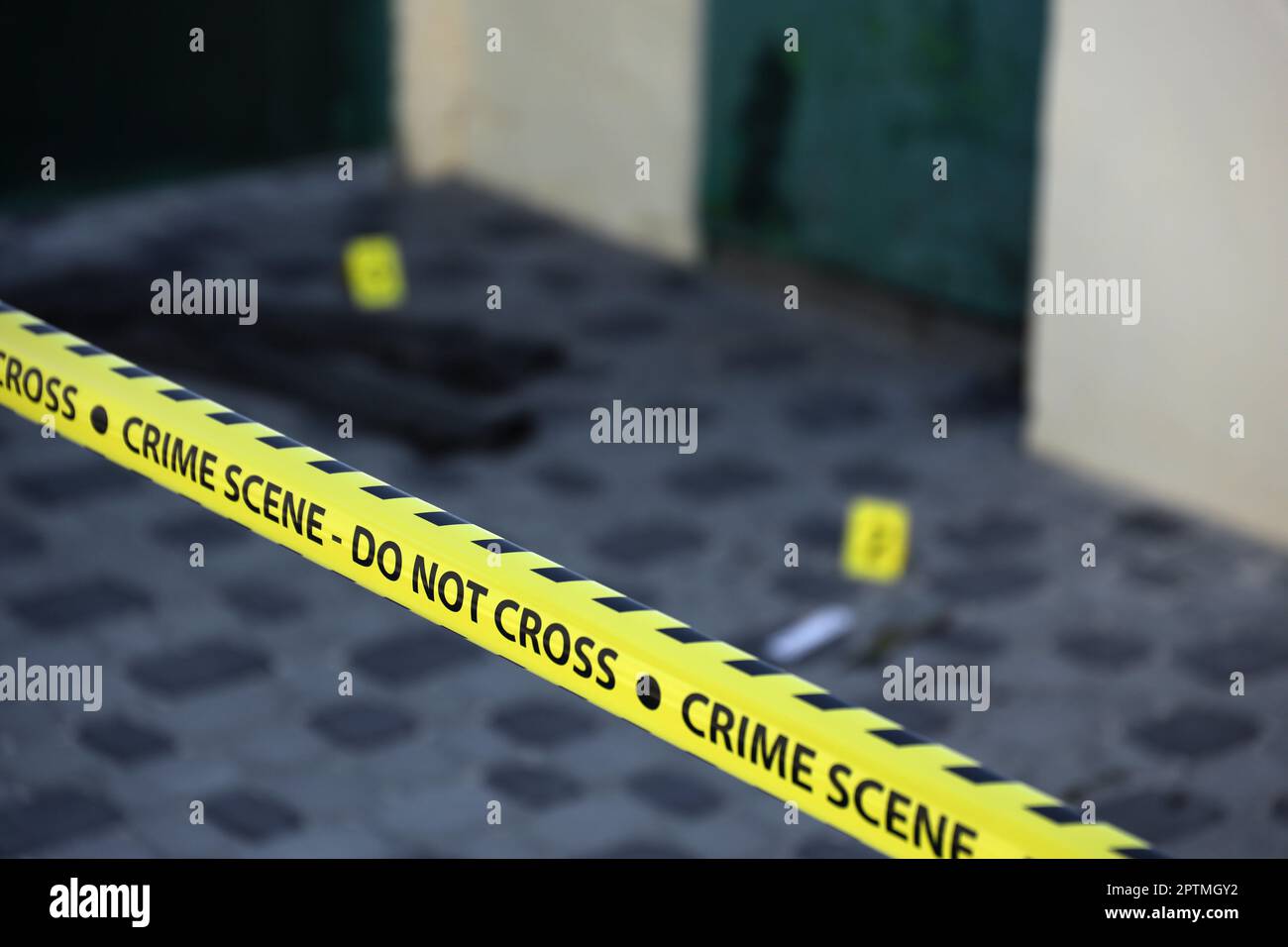 Crime scene tape for covering the area cordon. Yellow tape with blurred ...