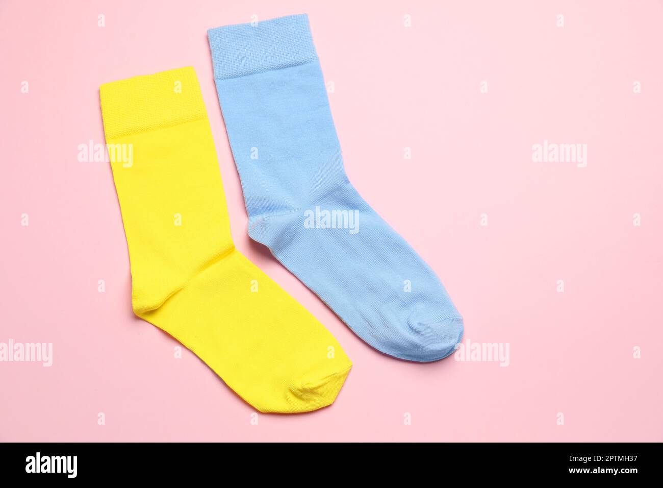 Colorful socks on light pink background, flat lay. Space for text Stock ...