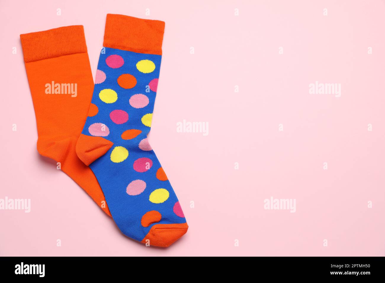 Colorful socks on light pink background, flat lay. Space for text Stock ...
