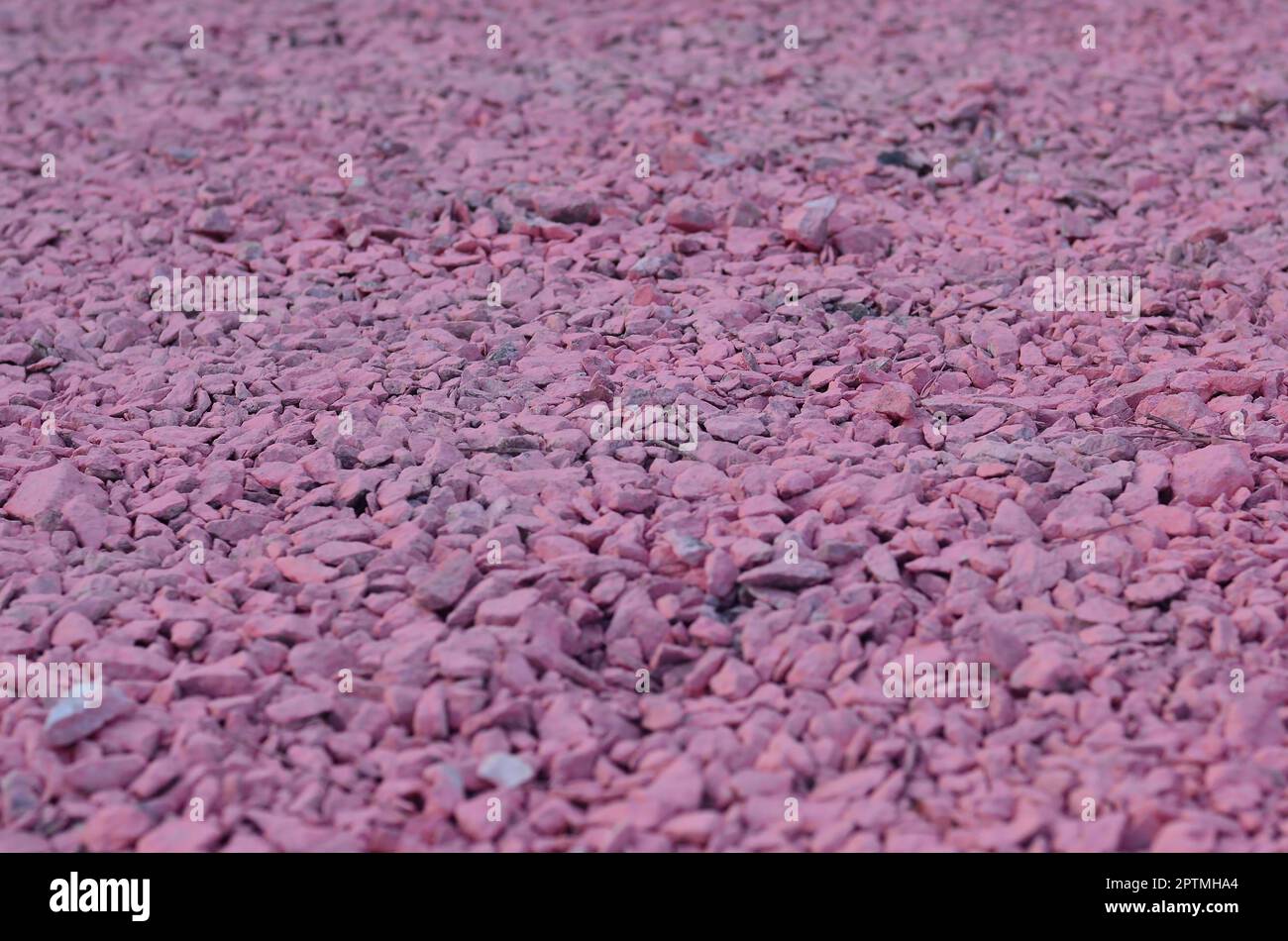 Texture from a pile of crushed stone, painted in light pink color ...