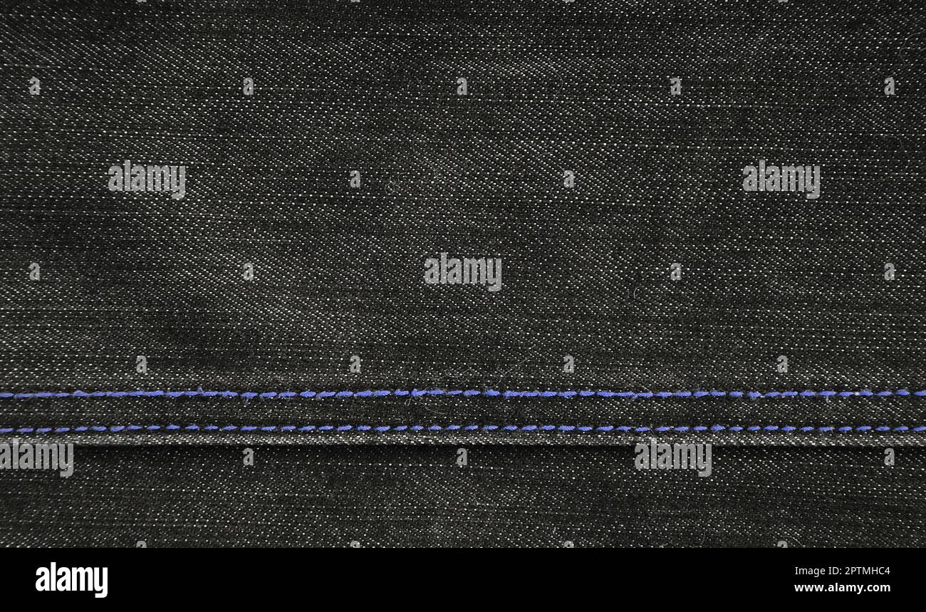 The texture of classic black denim cloth. Dark jeans background with ...