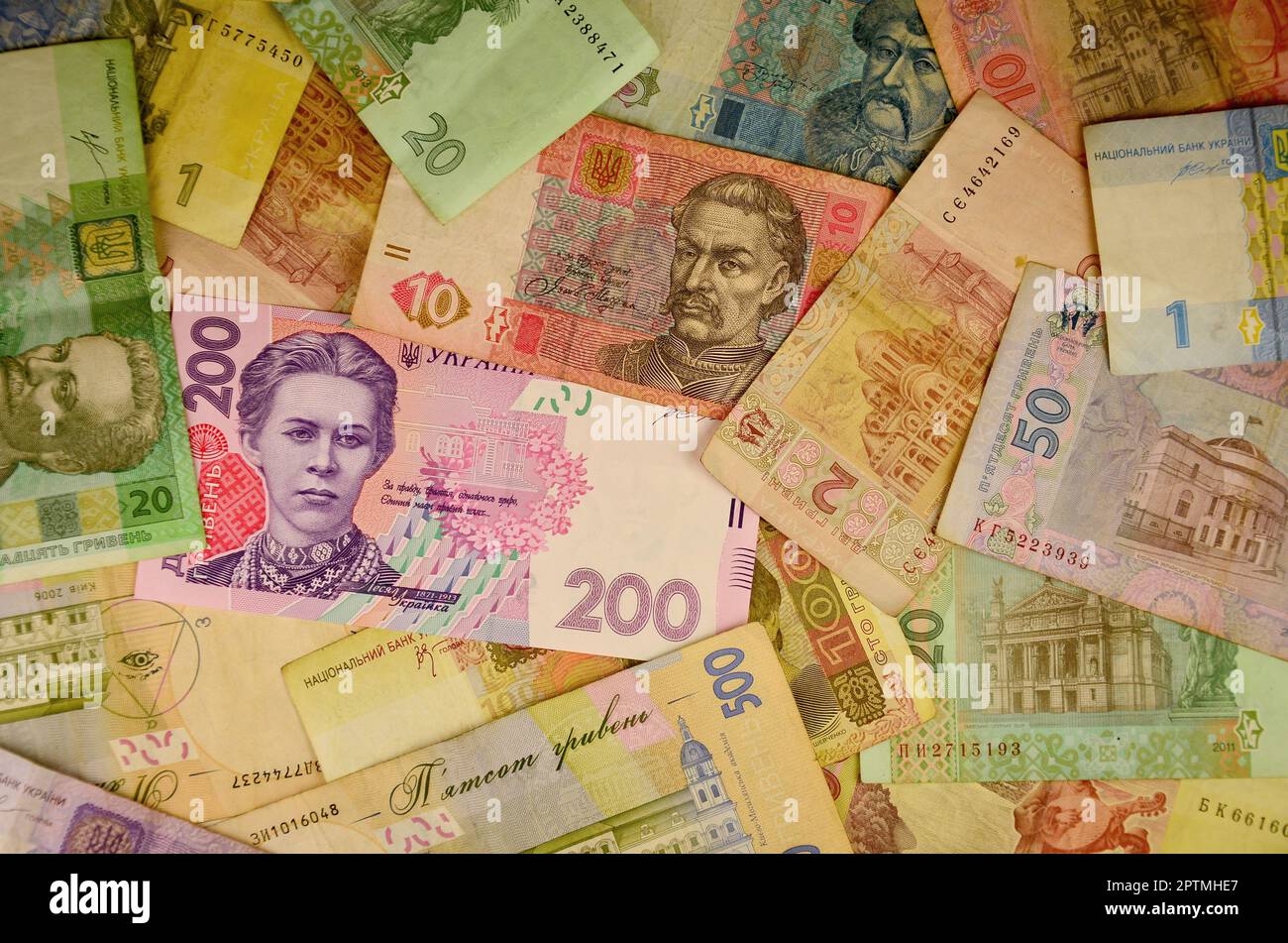 Many Ukrainian money bills of various denominations and colors ...