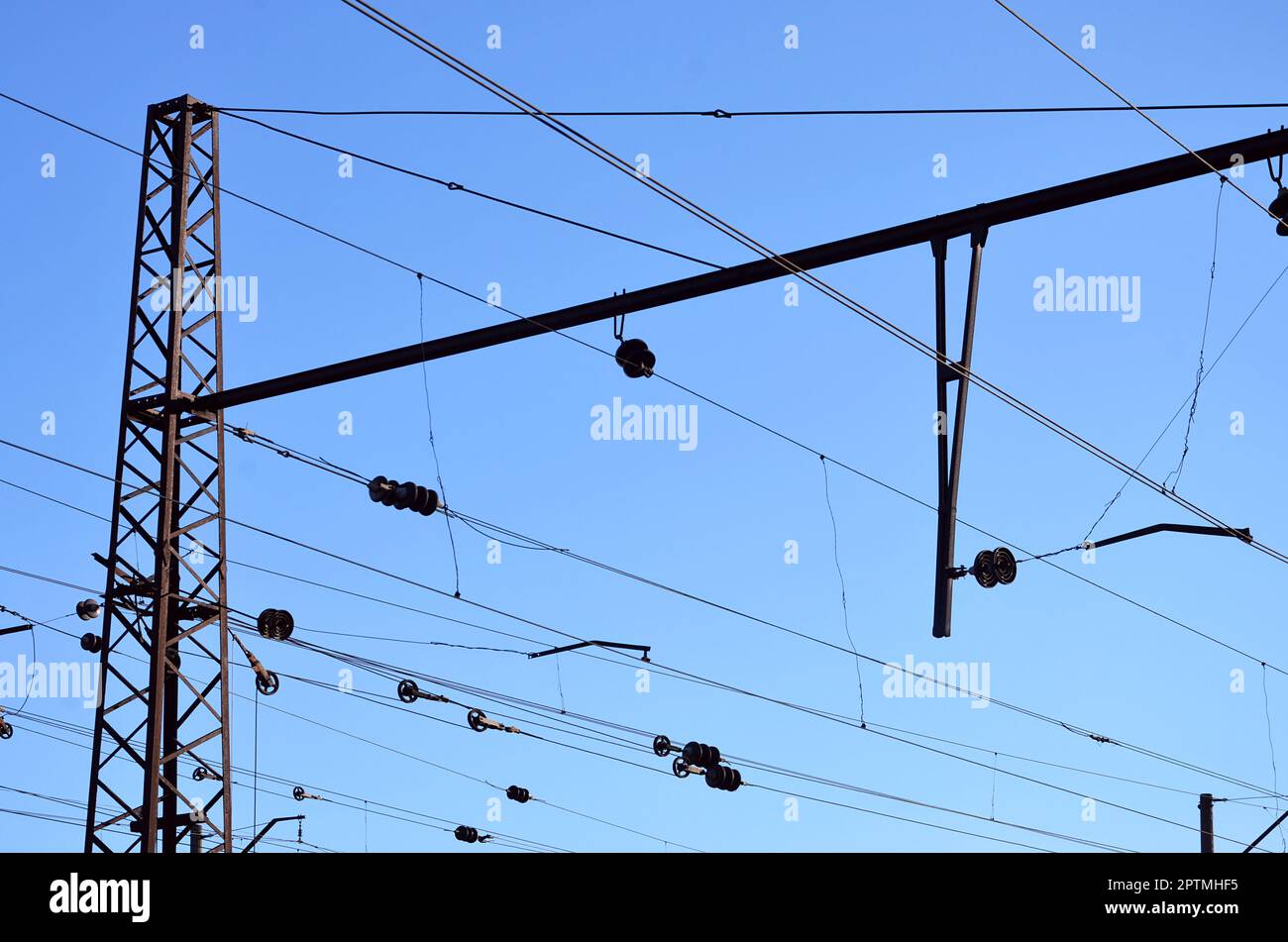 Railroad overhead lines against clear blue sky, Contact wire. High ...