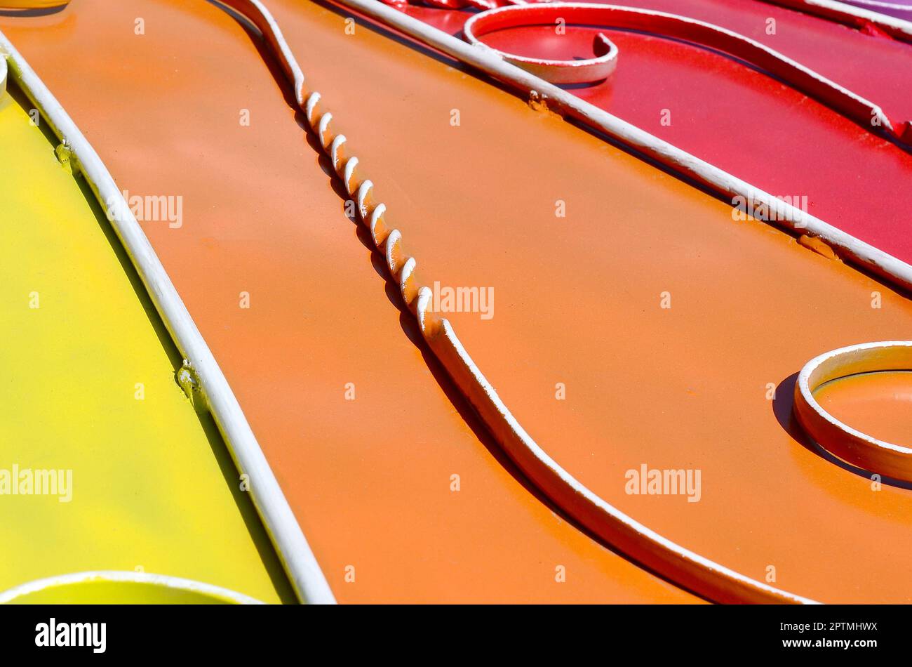 Metal texture of a piece of colored wall with a forged pattern. Rainbow ...