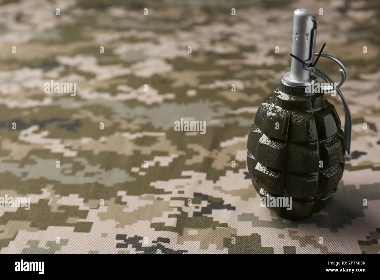 Hand grenade on digital camouflage fabric. Space for text Stock Photo ...