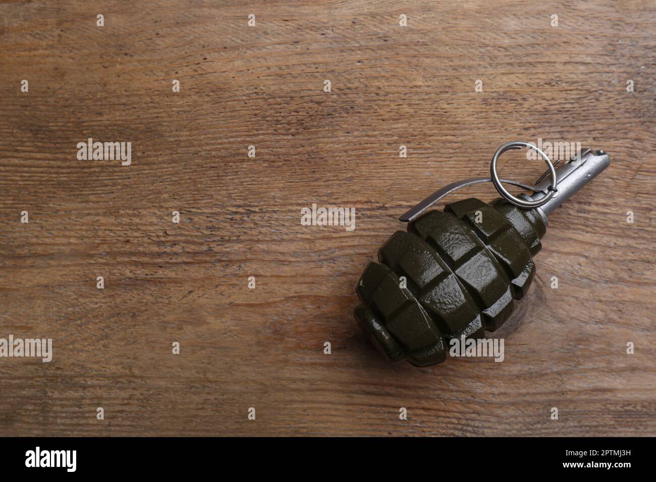 Hand grenade on wooden table, top view. Space for text Stock Photo - Alamy