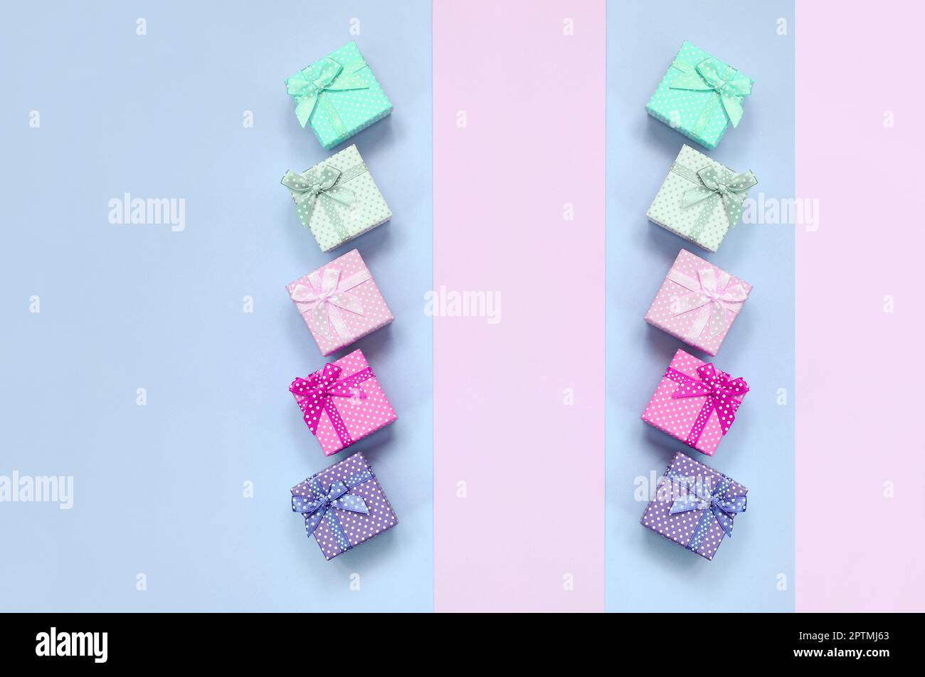 Small gift boxes of different colors with ribbons lies on a violet and ...