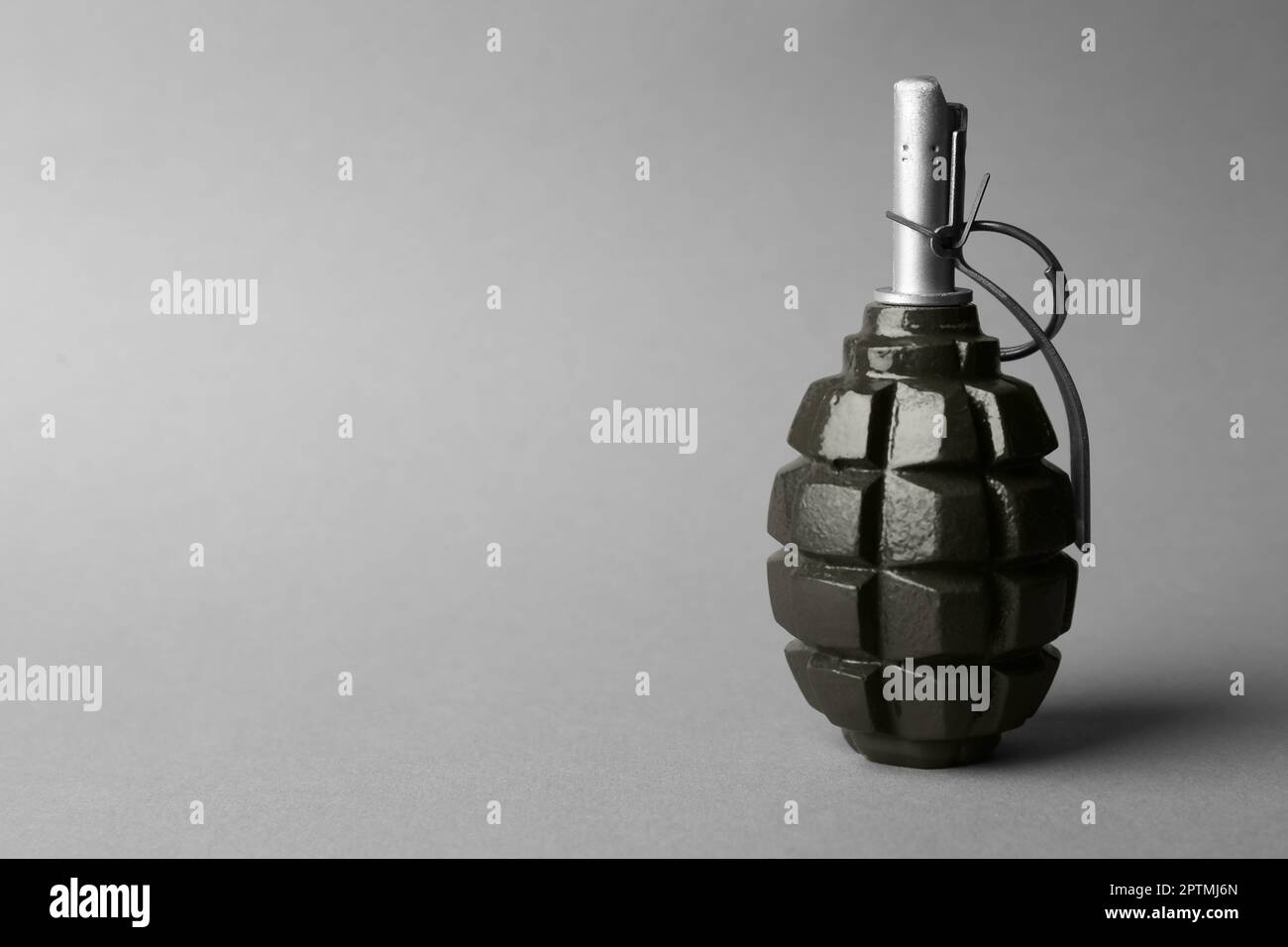 Hand grenade on grey background. Space for text Stock Photo - Alamy