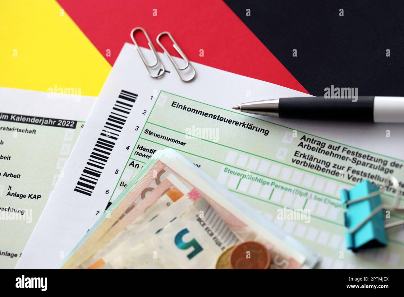 German income tax return form with pen and european euro money bills ...