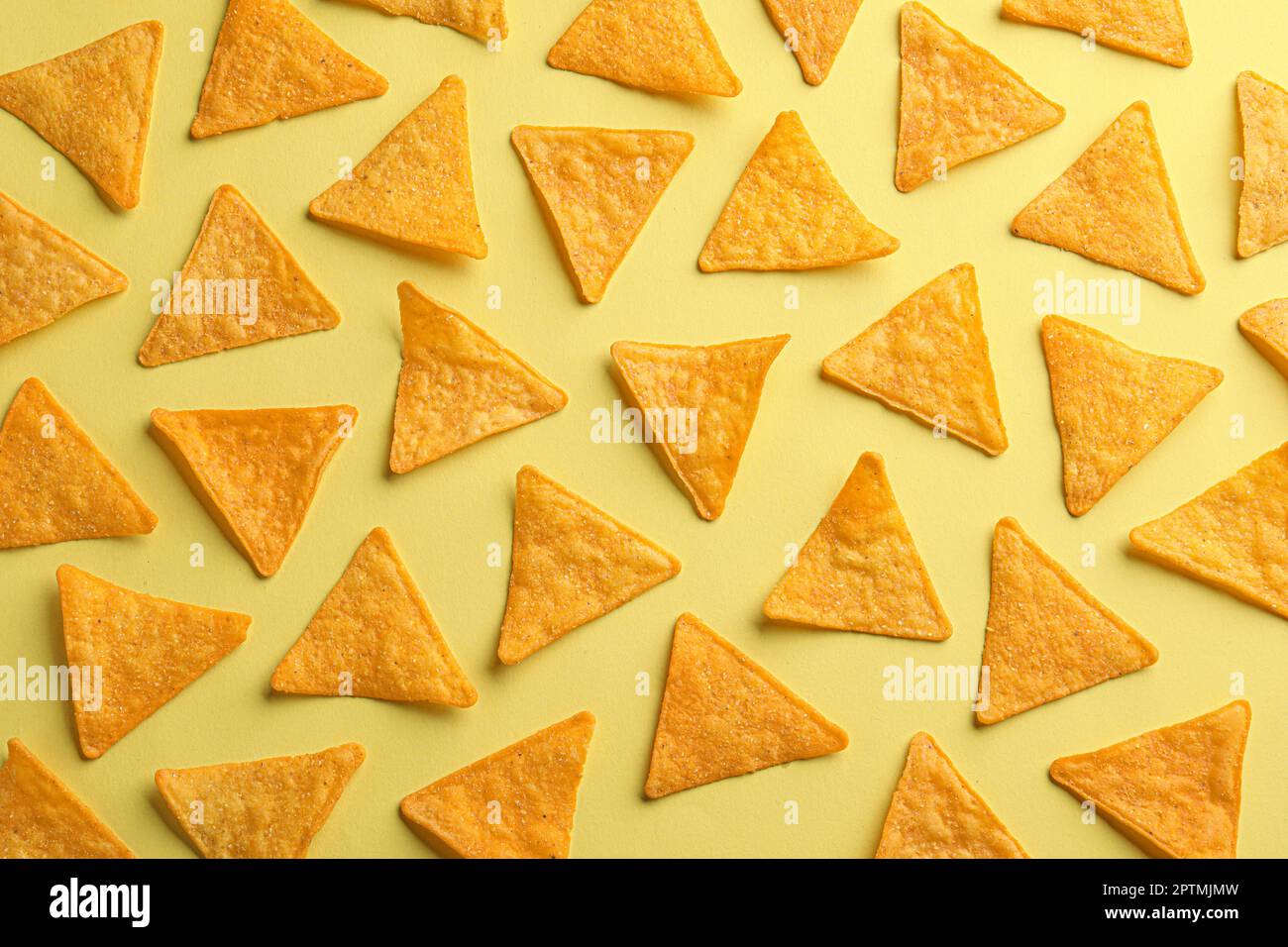 Flat lay composition of tortilla chips (nachos) on yellow background ...